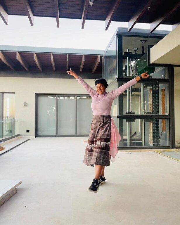 Asavela and her husband show off their newly-built home